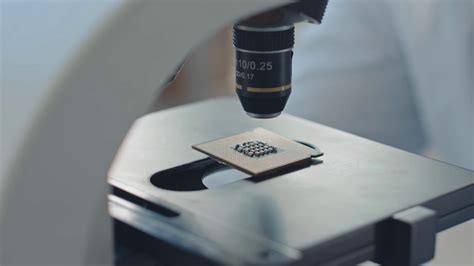 Slowmo Closeup Of Computer Chip Under Microscope Being Inspected By