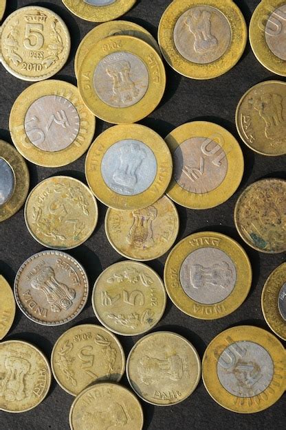 Premium Photo Mix Of Gold Colored Indian Rupee Coin Currency On Rustic Floor Full Frame Table