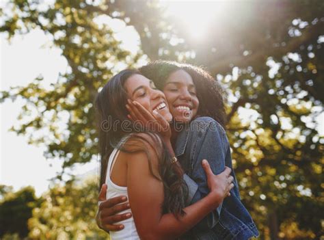 Smiling Portrait Of A Diverse Young Female With Eyes Closed Cuddling