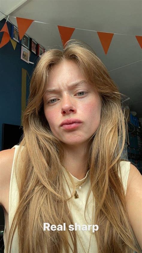 A Woman With Long Blonde Hair Is Looking At The Camera