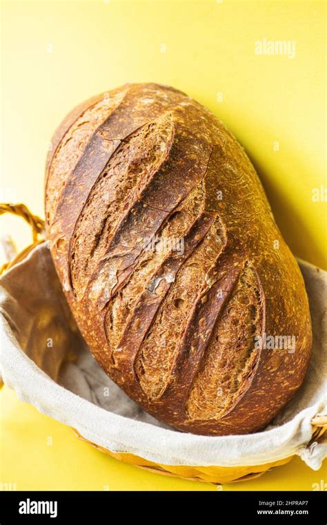 Homemade Artisanal Sourdough Bread In A Bread Basket Yellow Background