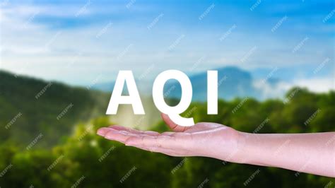 Premium Photo Aqi Abbreviation Of Air Quality Index Hand Holding Aqi On Nature Background