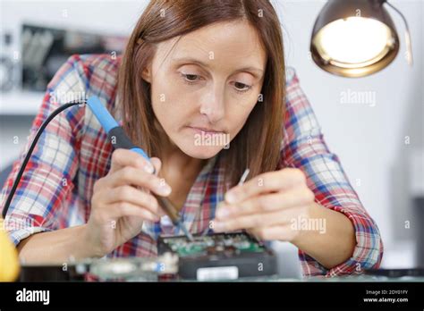 Woman Soldering Elements Of Circuit Board Stock Photo Alamy