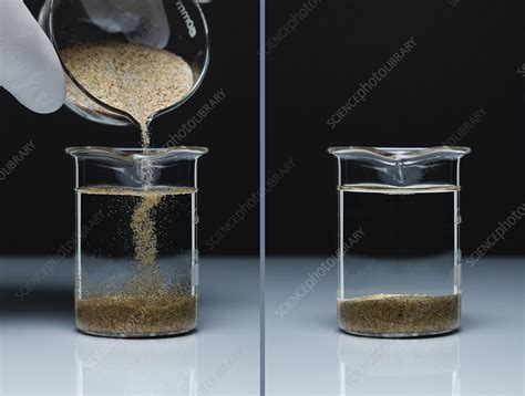 Sand And Water Mixed In A Glass