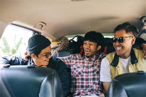 Premium Photo Three Best Male Friends Travel Together Sitting In A