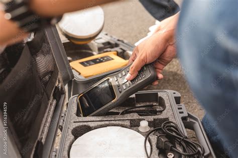 Geodetic Engineers Setting Up Real Time Kinematic Or Rtk Surveying Equipment Used In The Field