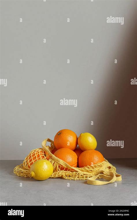 Zero Waste Packaging Oranges And Lemons In A String Bag On The Table