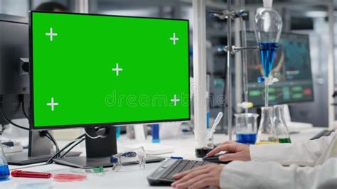 Scientist Using Green Screen Computer In Laboratory Driving Treatment