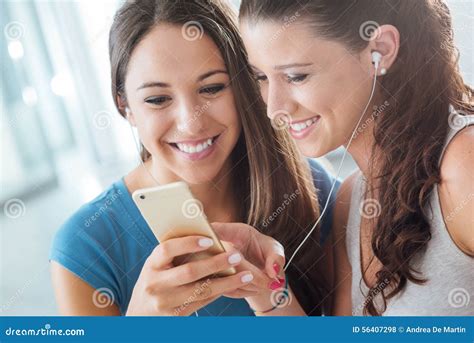 Girls Sharing Secrets In Classroom Royalty Free Stock Image