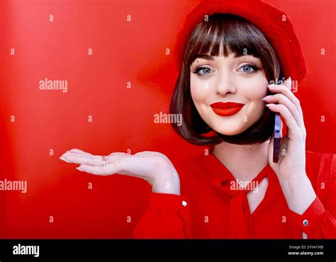 A Girl With A Bob Hairstyle Is Holding A Bilge In Her Hands The Girl Is Wearing A Shirt With A