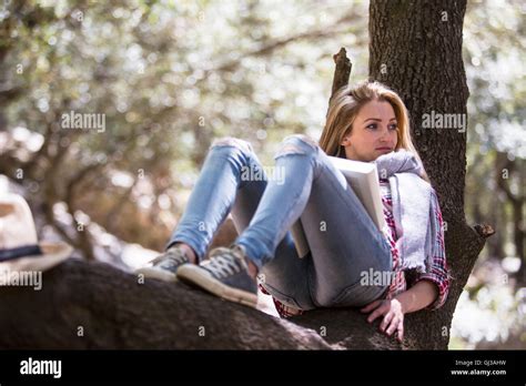 Woman Sitting In Tree Stock Photo Alamy