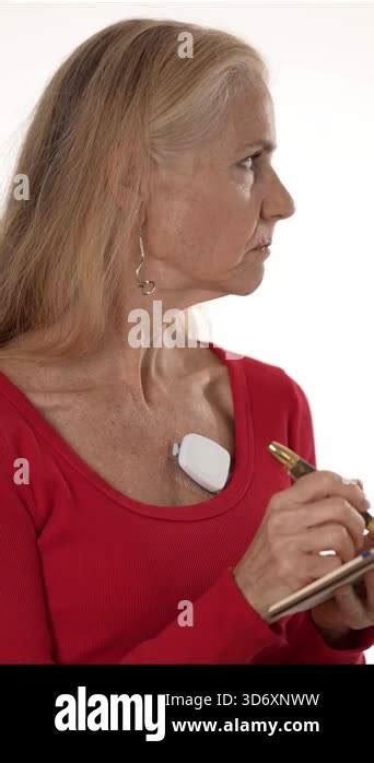 Vertical Video Of Mature Woman Is Engaged In Monitoring Her Heart