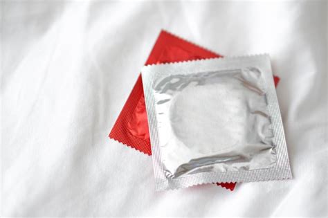 Premium Photo Directly Above Shot Of Condom Packets On Bed