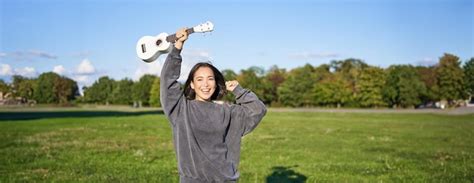 Premium Photo Upbeat Young Woman Dancing With Her Musical Instrument