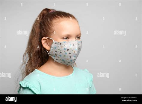 Preteen Girl In Protective Face Mask On Light Grey Background Stock