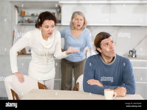 Man Turned Away From His Wife And Mother Swearing At Him In Kitchen At