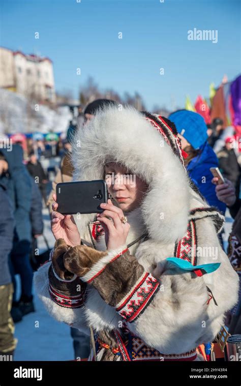 Nenet Girl In Traditional Clothes Taking Picture With A Smartphone At