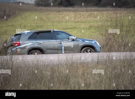 A Stolen Abandoned Car In A Ditch Marked With Blue White Police Tape Stock Photo Alamy