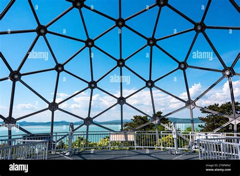 A Lookout With A Triangular Metal Grid Structure On The Shore Of A Lake