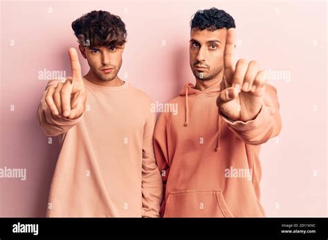 Young Gay Couple Wearing Casual Clothes Pointing With Finger Up And