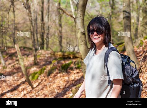 A Girl With Sunglasses Is Enjoying The Outdoors On A Hiking Trail Her