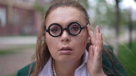 Portrait Of A Nerd Guy And Stylish Plump Woman In Glasses Sitting At A