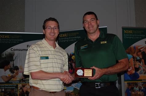 Sam Markell Right Receives The Communicator Of The Year Award From