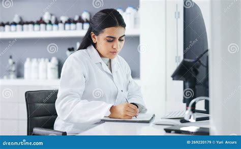 Young Scientist Using A Computer And Microscope In A Lab Female