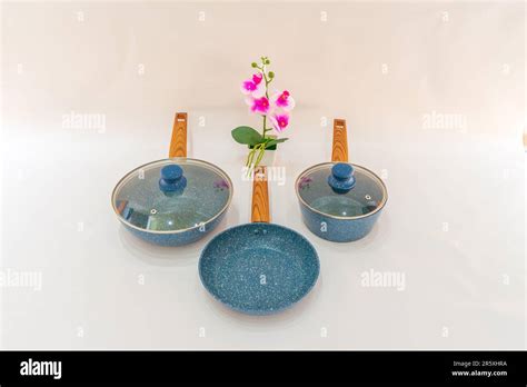 The Blue Pot And Fry Pan With Wooden Handle Is A Versatile And