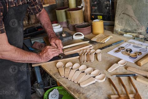Craftsman Carving Wooden Spoons In Workshop Artisan Shaping Wood With