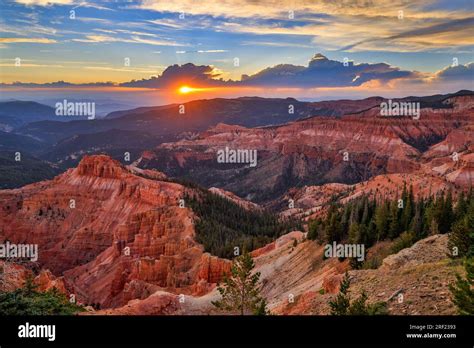The Sun Breaks Through The Clouds As It Sets Over The Amphitheater Of