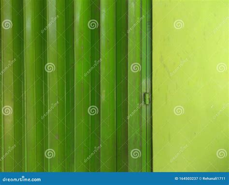 Green Color Harmonica Door And House Wall Suitable For Background Of