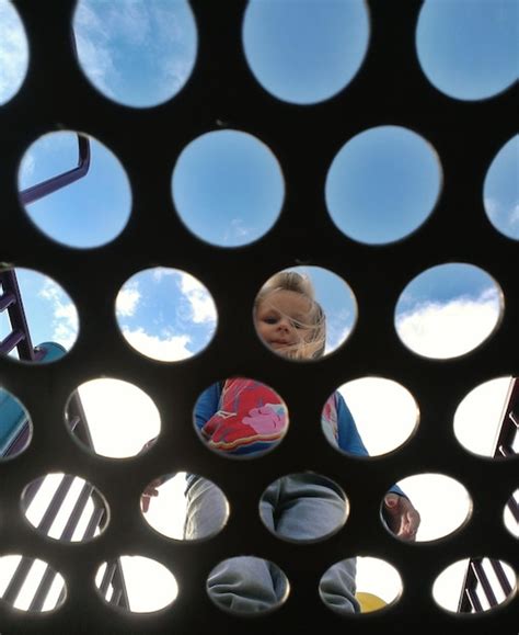 Premium Photo Low Angle View Of Girl Seen Through Holes Of Footbridge