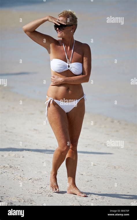 Healthy And Fit Looking Mature Woman In A White Bikini Alone On A Stock