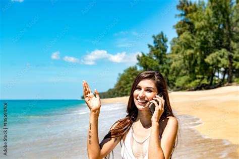 Beautiful Young Single White Woman On Beach Talking On Mobile Phone