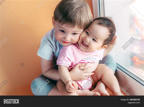 Older Brother And Sister Hugging