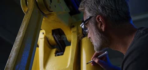 automation engineer checking servicing robotic arm concept of modern