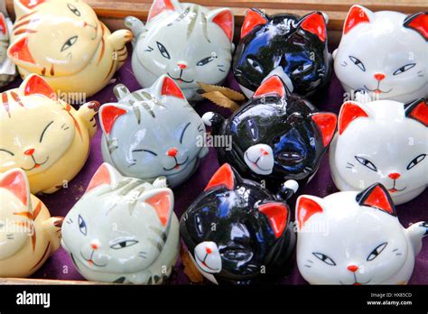 Porcelain Made Cartoon Cat Ornaments In Souvenir Shop Front On The Way