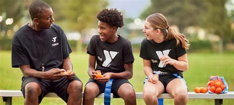 A Group Of People Sitting On A Bench
