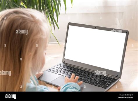 Preschool Girl Studying Distance Learning Course Using Computer Monitor With White Screen