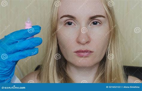 Examination Of The Fundus And Dilated Pupils A Doctor Performs An Ophthalmoscopy On A Woman Who