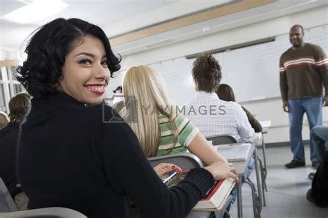 Portrait Of Young College Student With Classmates Attending Lecture By