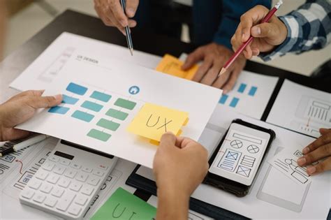 Premium Photo Ui Designer Brainstorming About Mobile App Interface Wireframe Design With