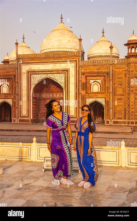 Two Girls Posing In Front Of Taj Mahal Tomb In Agrauttar Pradeshindia