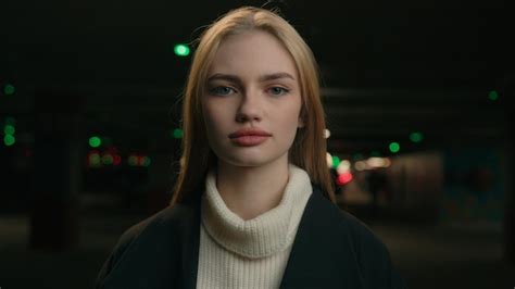 Premium Photo Calm Lady Caucasian Woman Stand Alone On Dark Parking