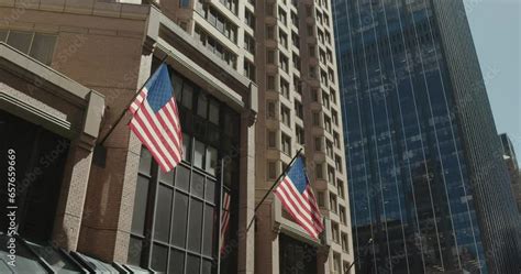 Two American National Flags Hanging On A Monumental Historic Building