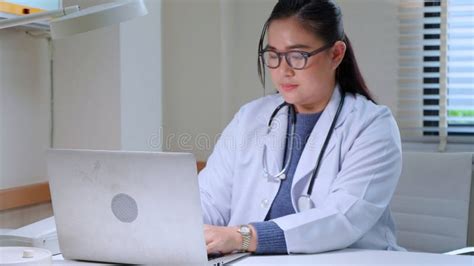 Specialist Doctor Asian Woman Working On Laptop Computer For Records