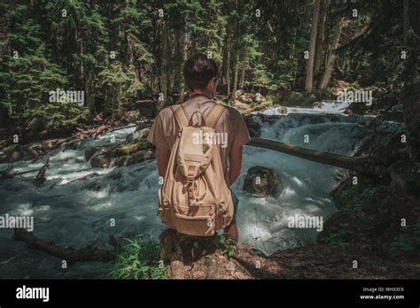 Feet Man Hiking Outdoor With River And Forest On Background Lifestyle