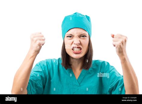 Nurse Exhibiting Anger With Fists Raised In Teal Uniform Against A White Background Stock Photo