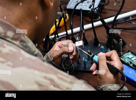 An Airman Assigned To Task Force 99 Solders Components At Al Udeid Air Base Qatar October 28